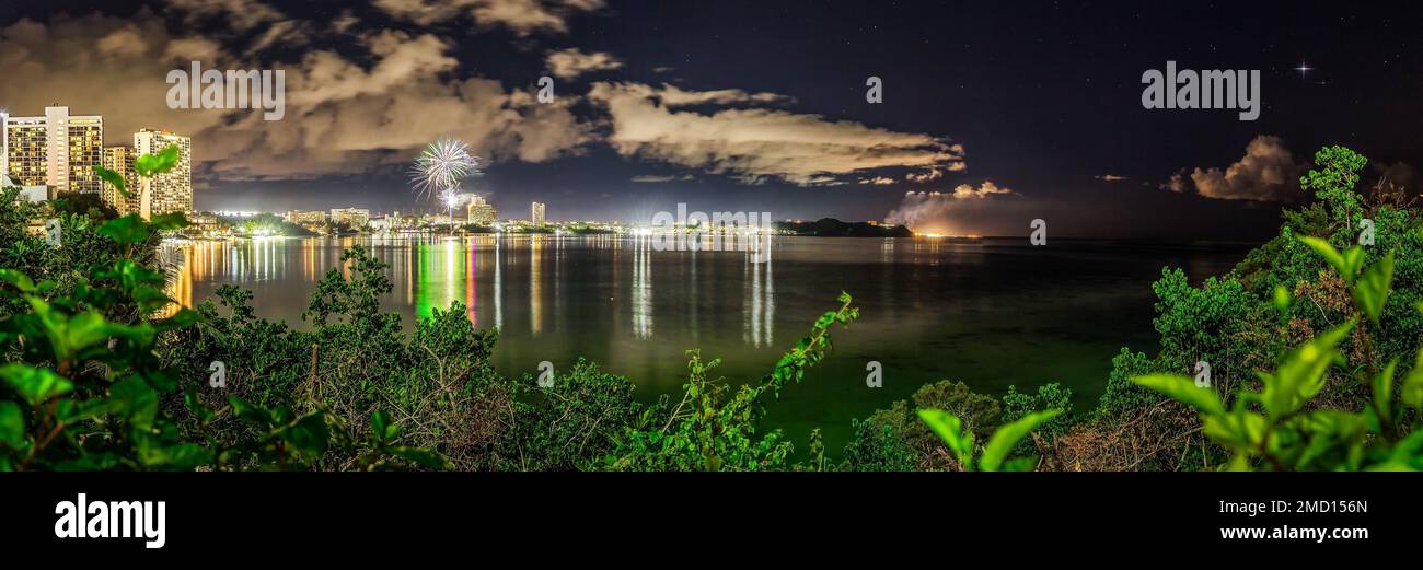 A beautiful view of an urban city and ocean water at night Stock Photo ...