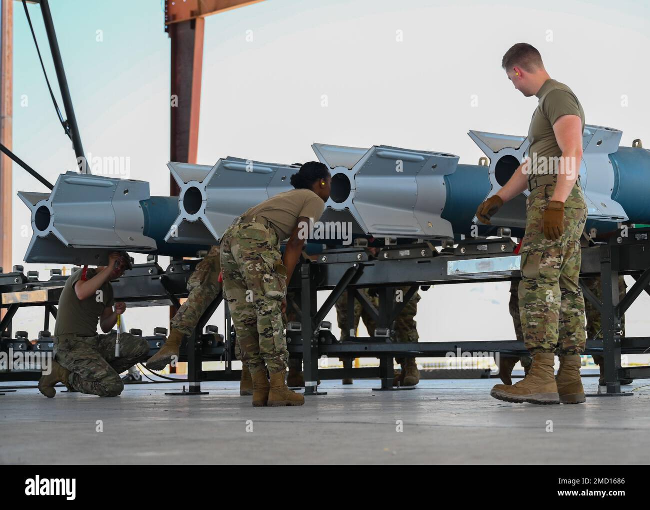 U.S. Air Force Airmen assigned to the 1st and 57th Munitions Squadrons inspect GBU-10 Paveway II ...