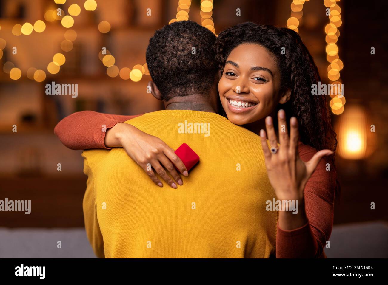 Cheerful black woman showing engagement ring, hugging her fiance Stock ...