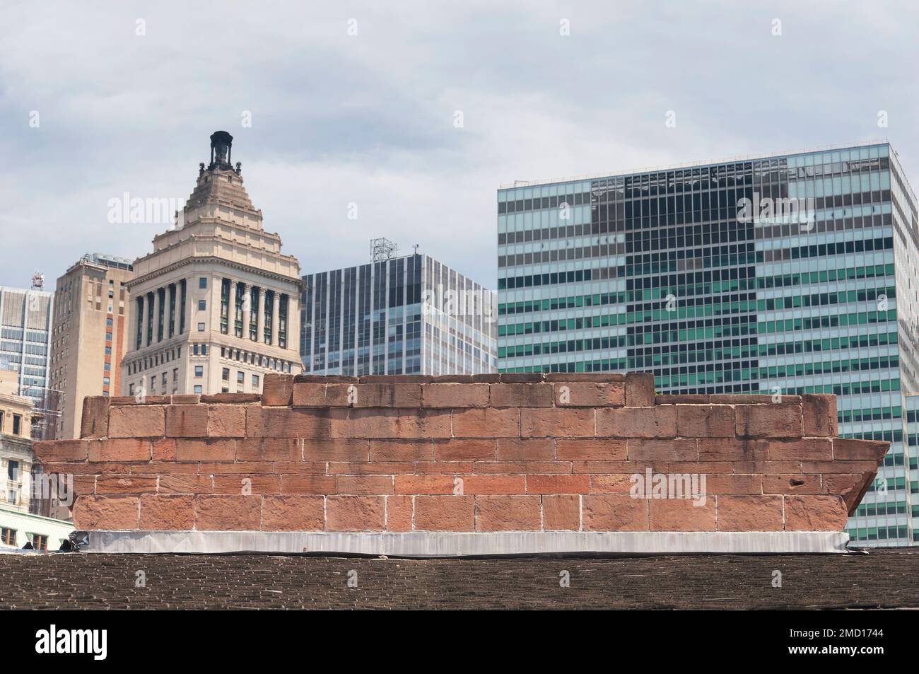 Lower Manhattan, new york city rising above the red brick wall of ...
