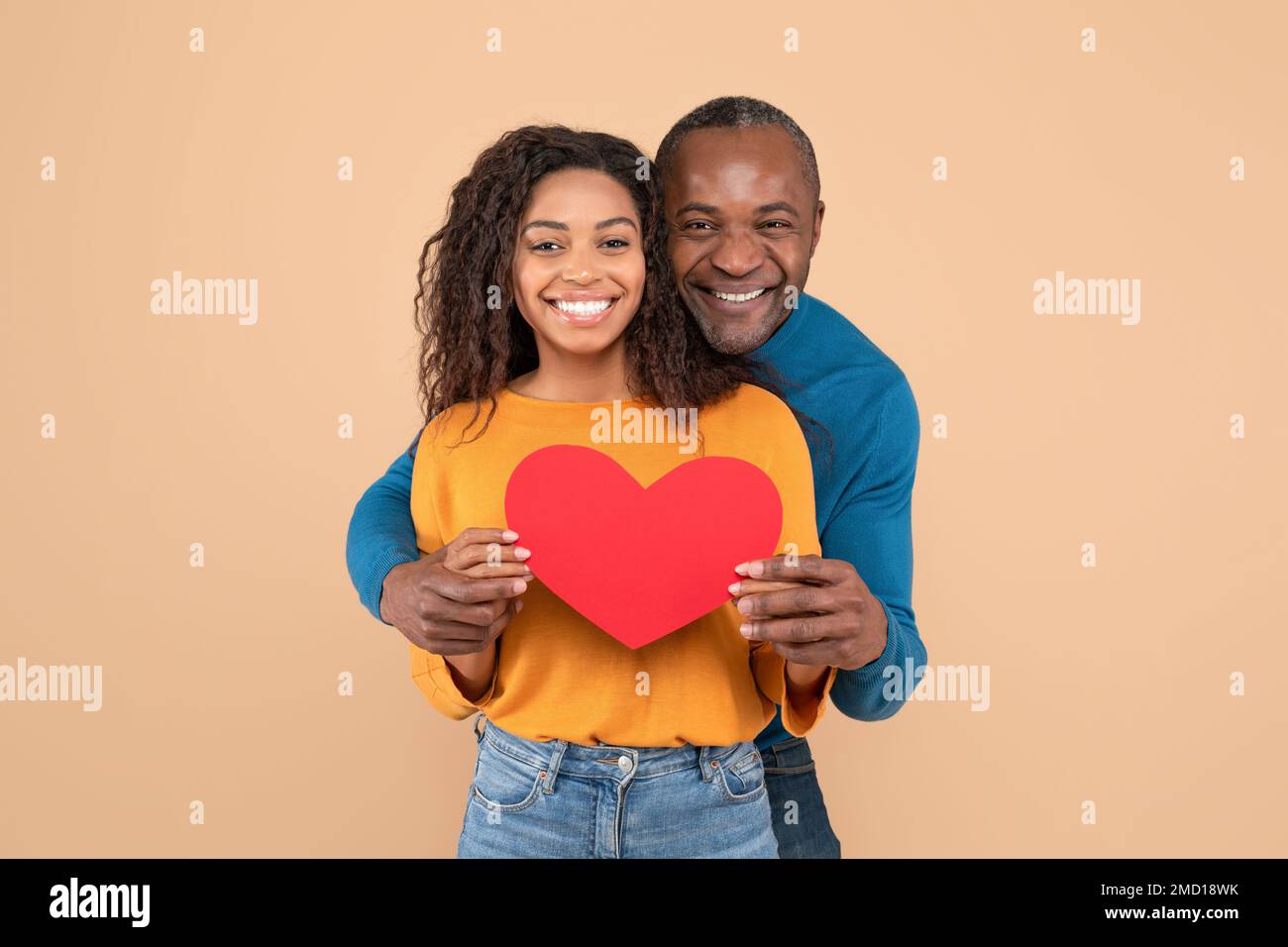 Valentine's holiday. Loving african american spouses holding paper ...