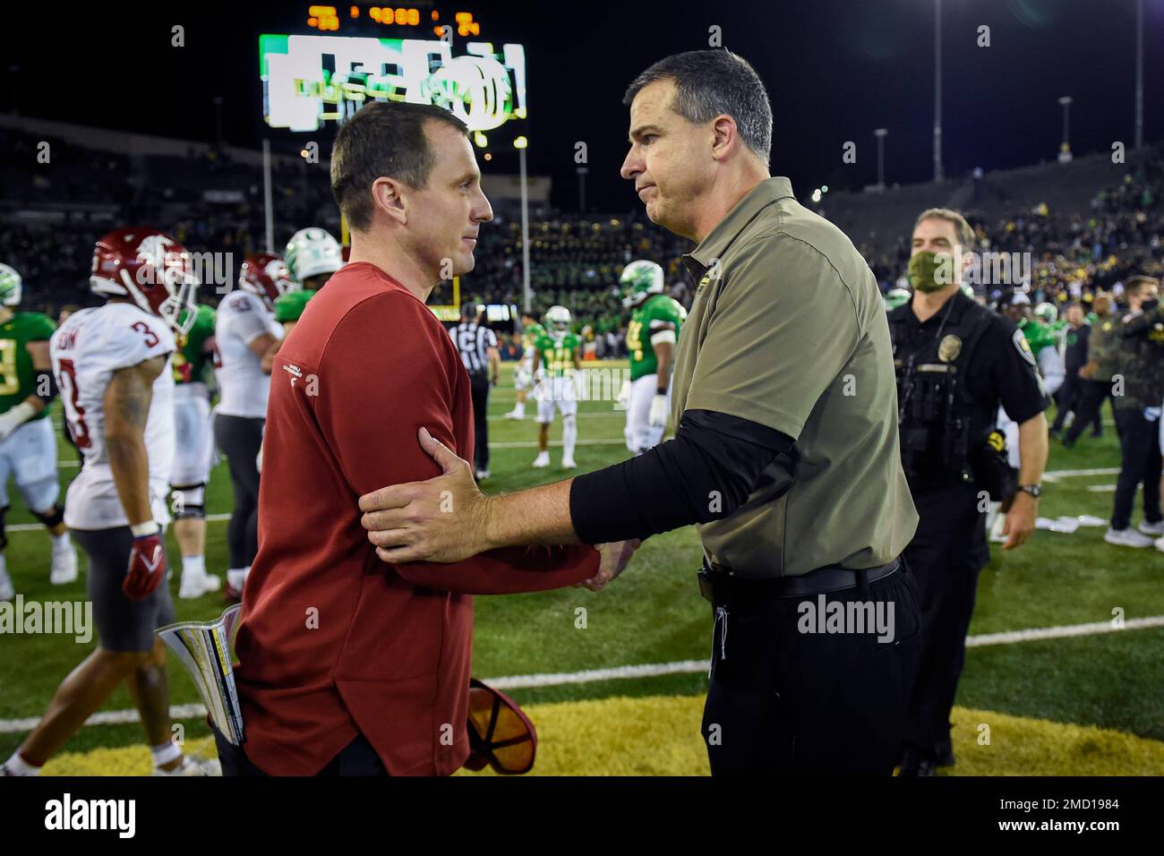 Washington State head coach Jake Dickert, left, and Oregon head coach ...