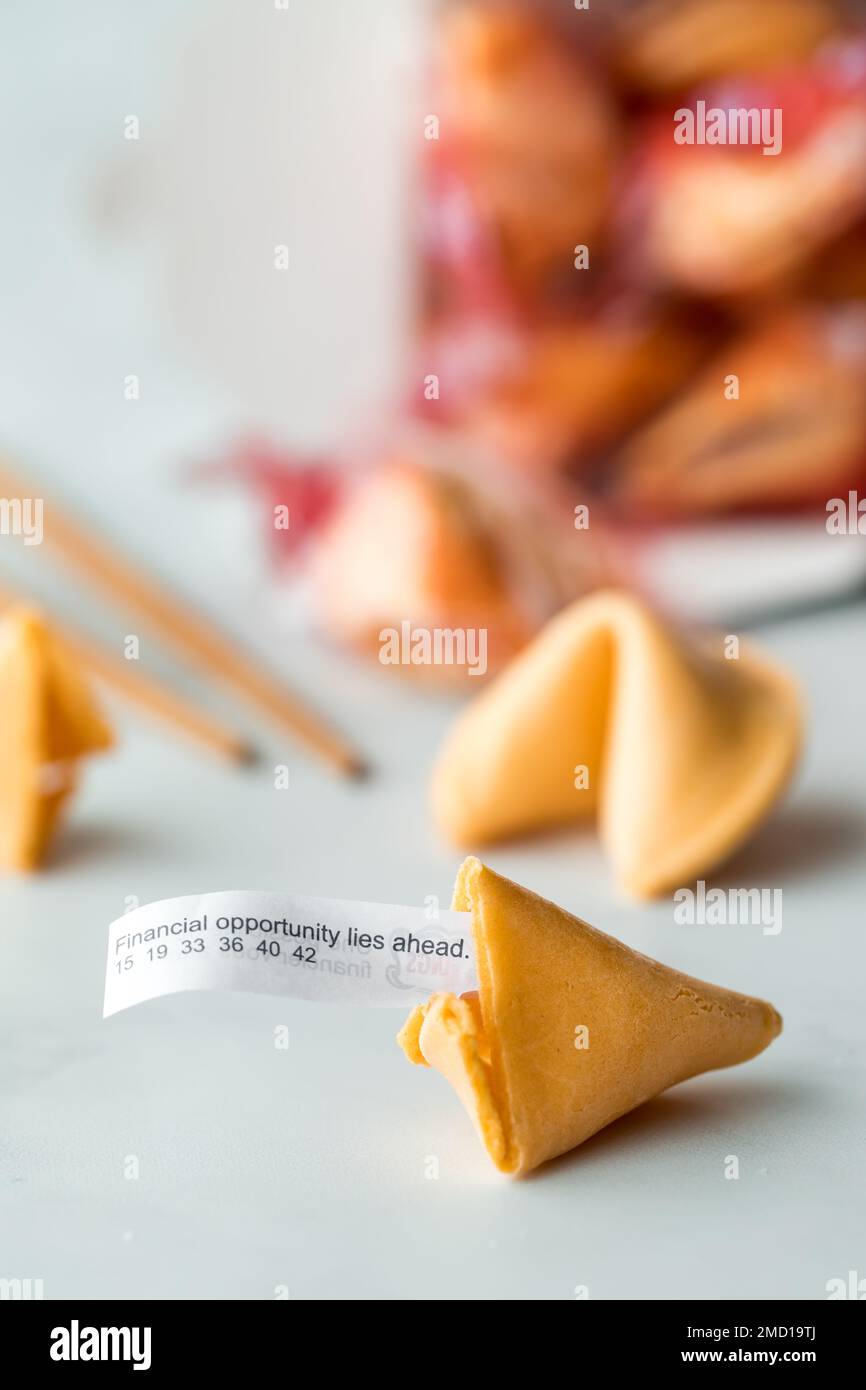 Fortune cookies with a fortune note sticking out of the one in front ...