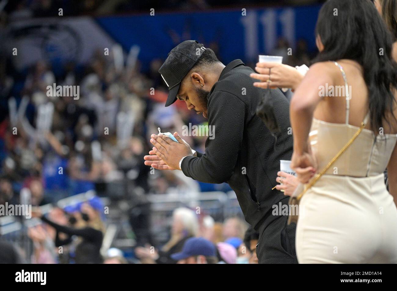 Rapper Deonte Moore, known as Moe, applauds from his court side seat ...