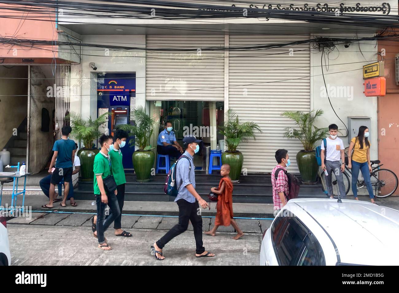 People walk past a bank and an ATM machine in Yangon, Myanmar on Nov ...