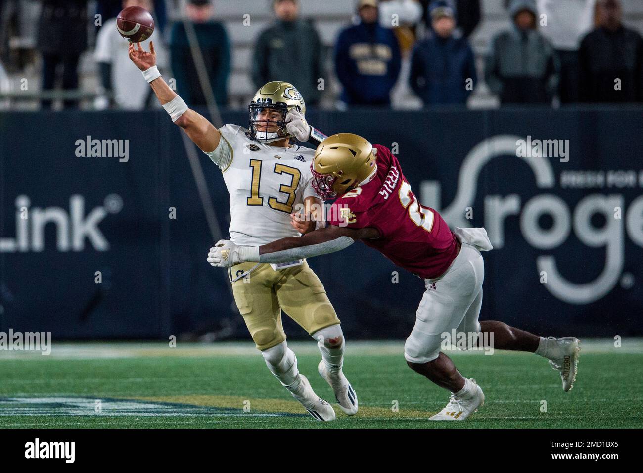 Georgia Tech quarterback Jordan Yates (13) throws a pass as he is hit ...