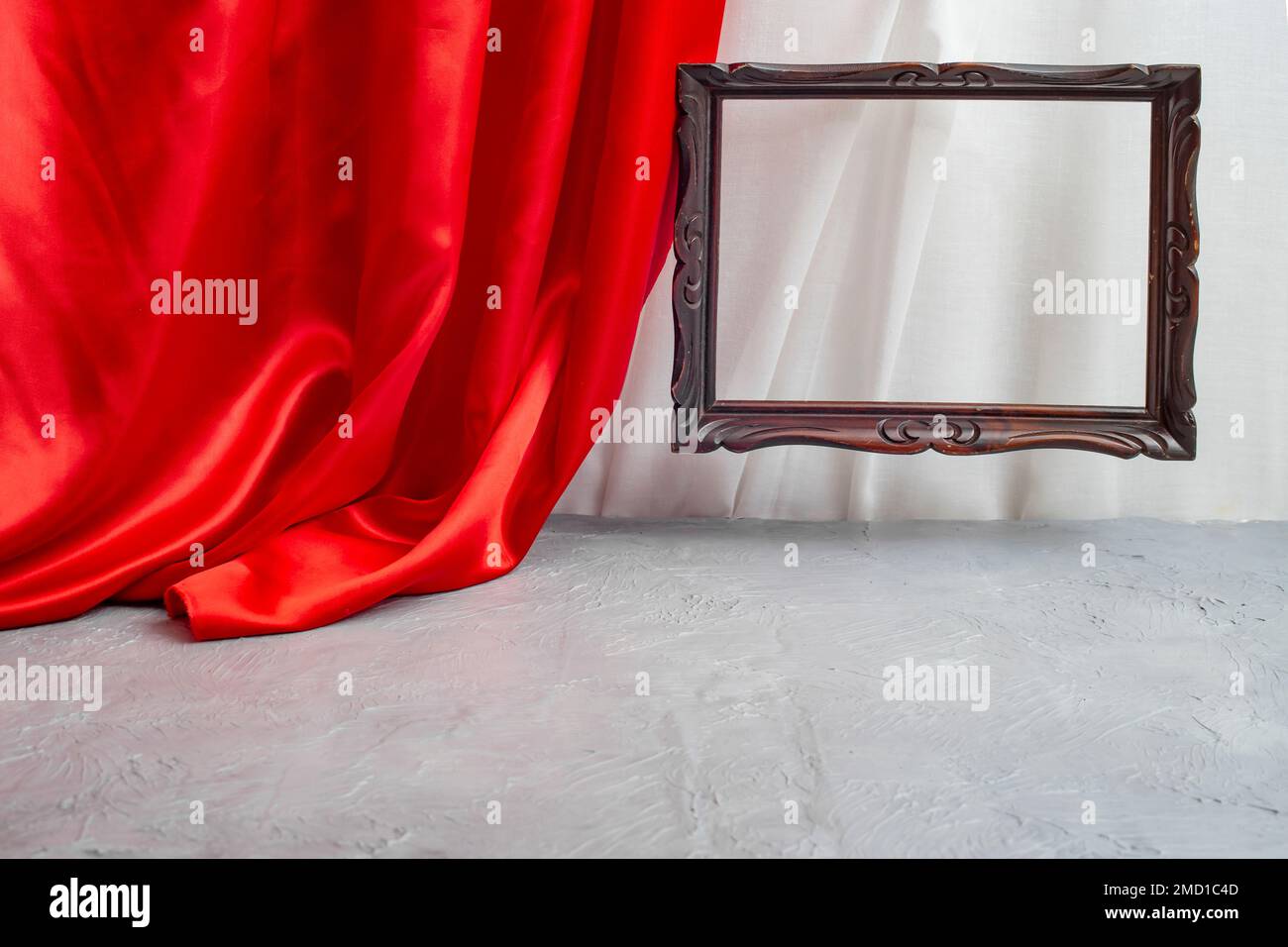 red satin curtain unveiling a wooden frame and cement textured stage ...