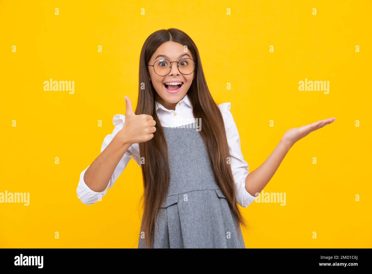 Teenager child pointing to the side with a finger to present a product ...
