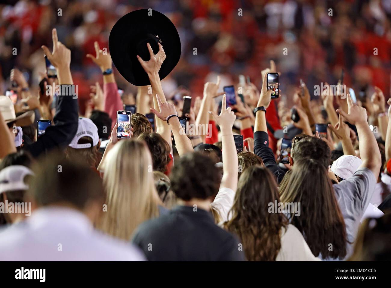 Texas Tech fans sing the school song on the field after an NCAA college ...