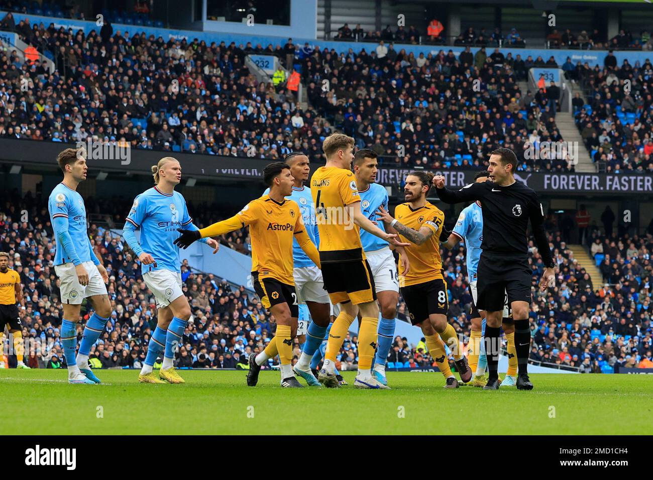 Players of both teams remonstrate with referee David Coote during the ...