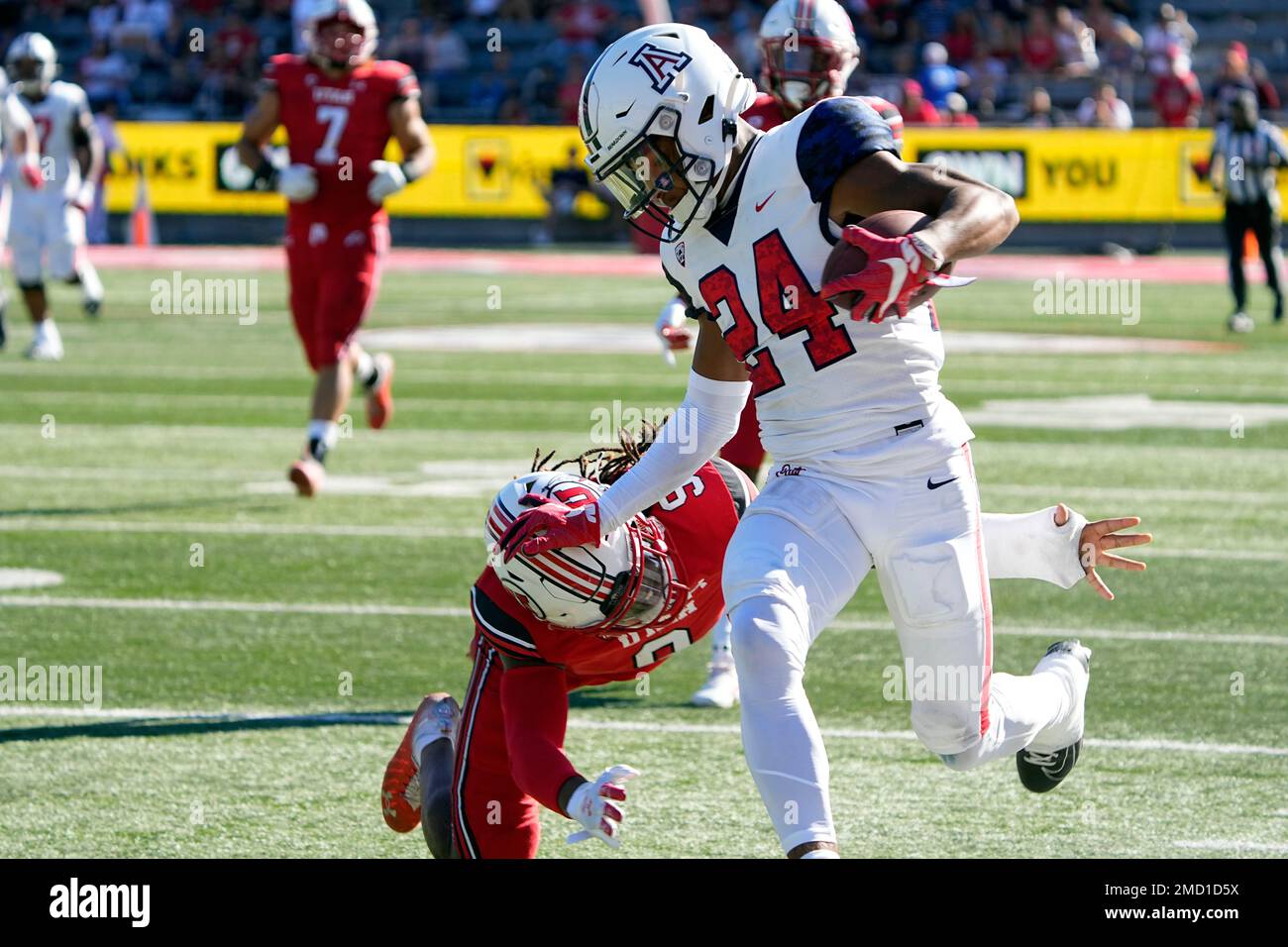 Arizona wide receiver Dorian Singer (24) stiff arms Utah safety Vonte ...