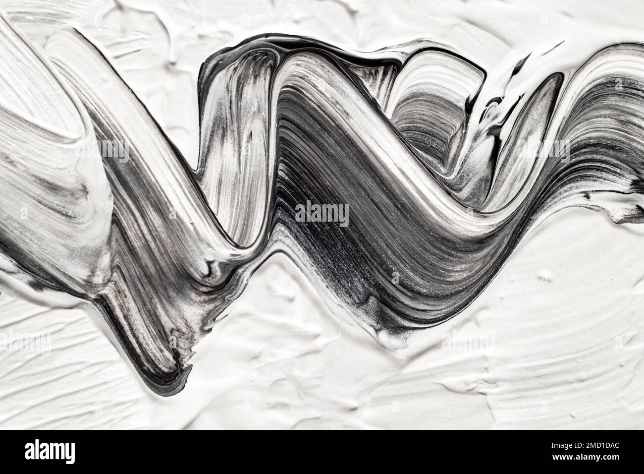 Black and white acrylic paint mixed on a palette, soft focus macro ...