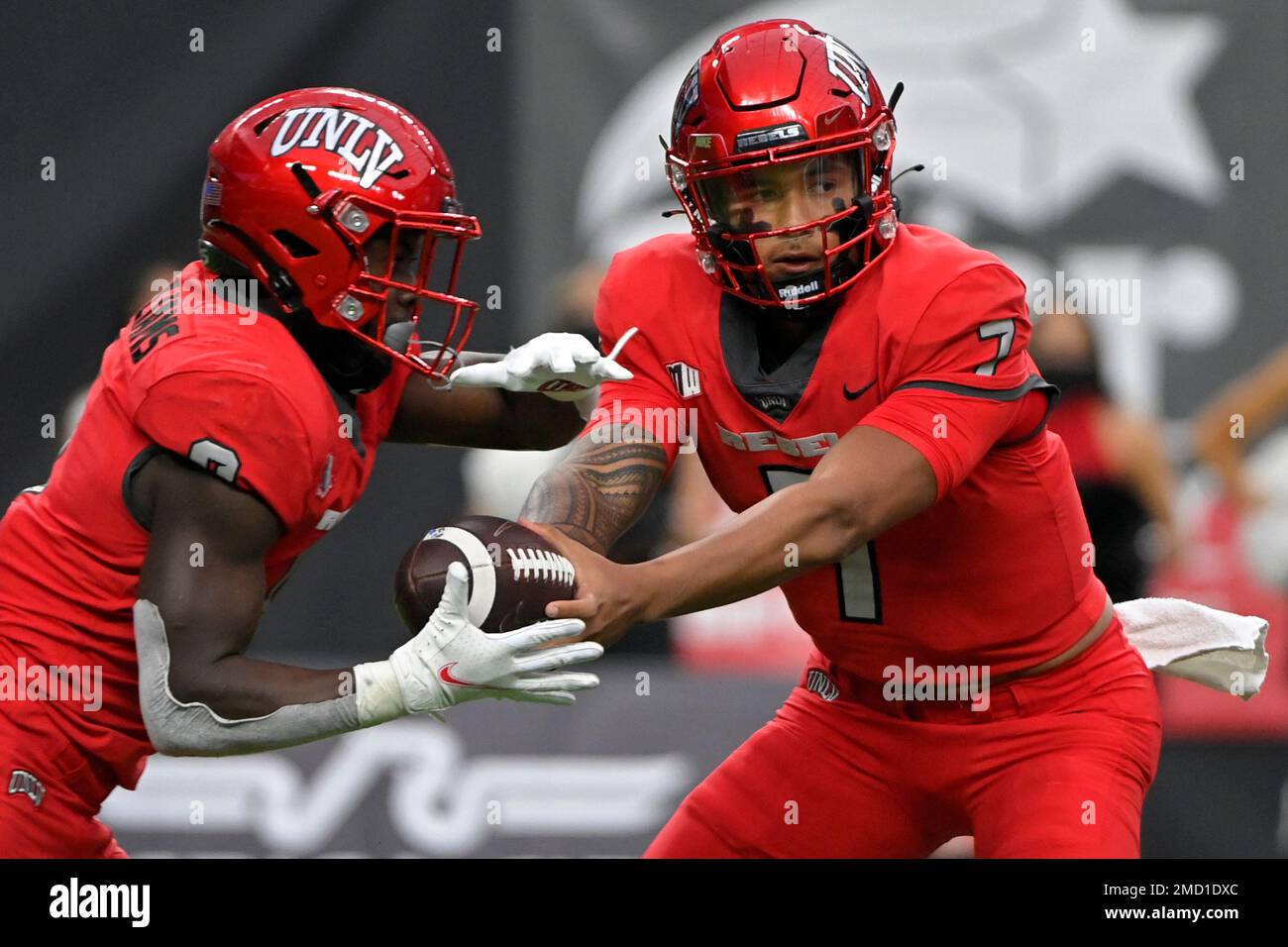 UNLV quarterback Cameron Friel (7) hands off the ball to running back ...