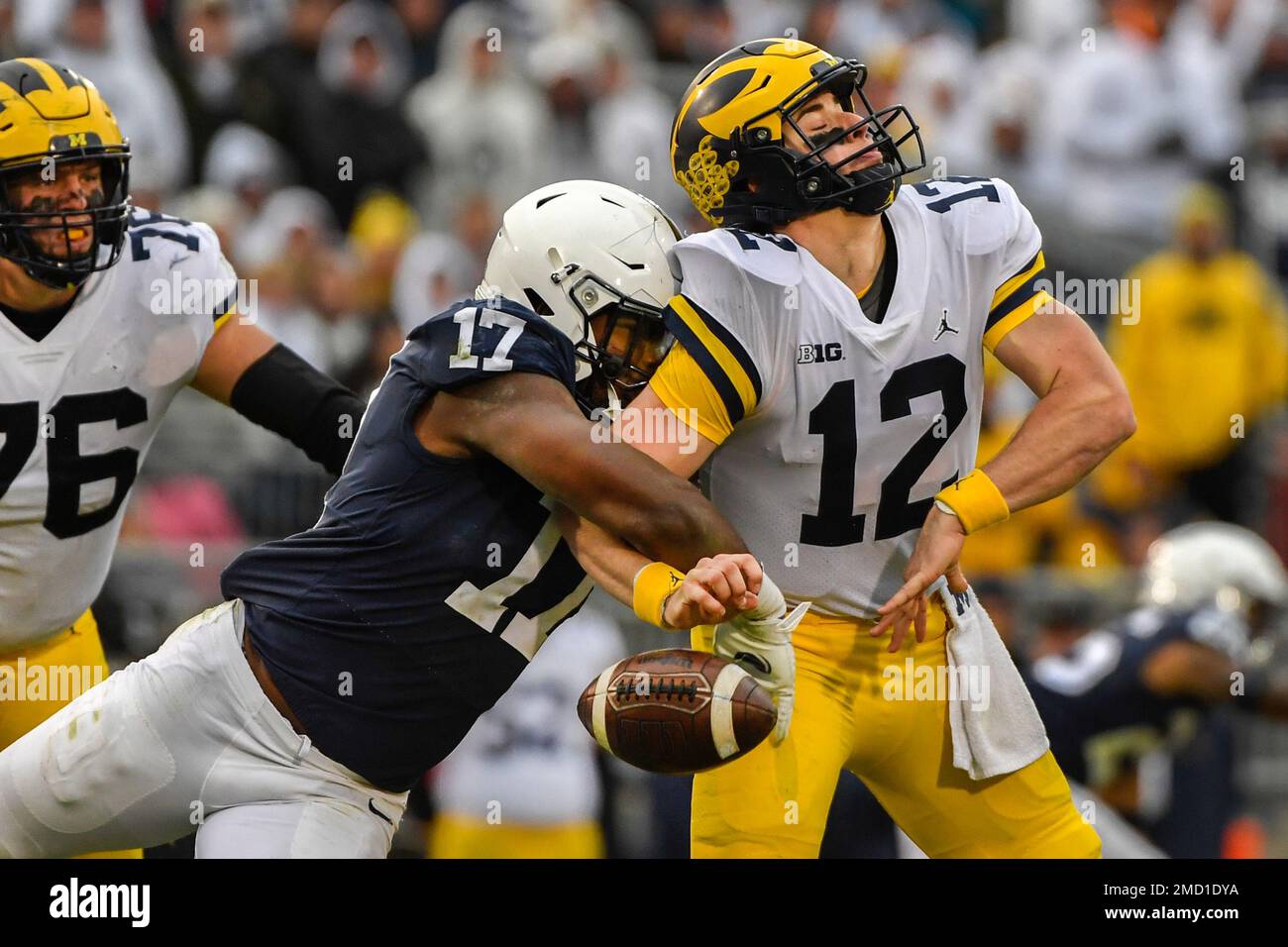 Penn State defensive end Arnold Ebiketie (17) forces a fumble by Michigan quarterback Cade ...