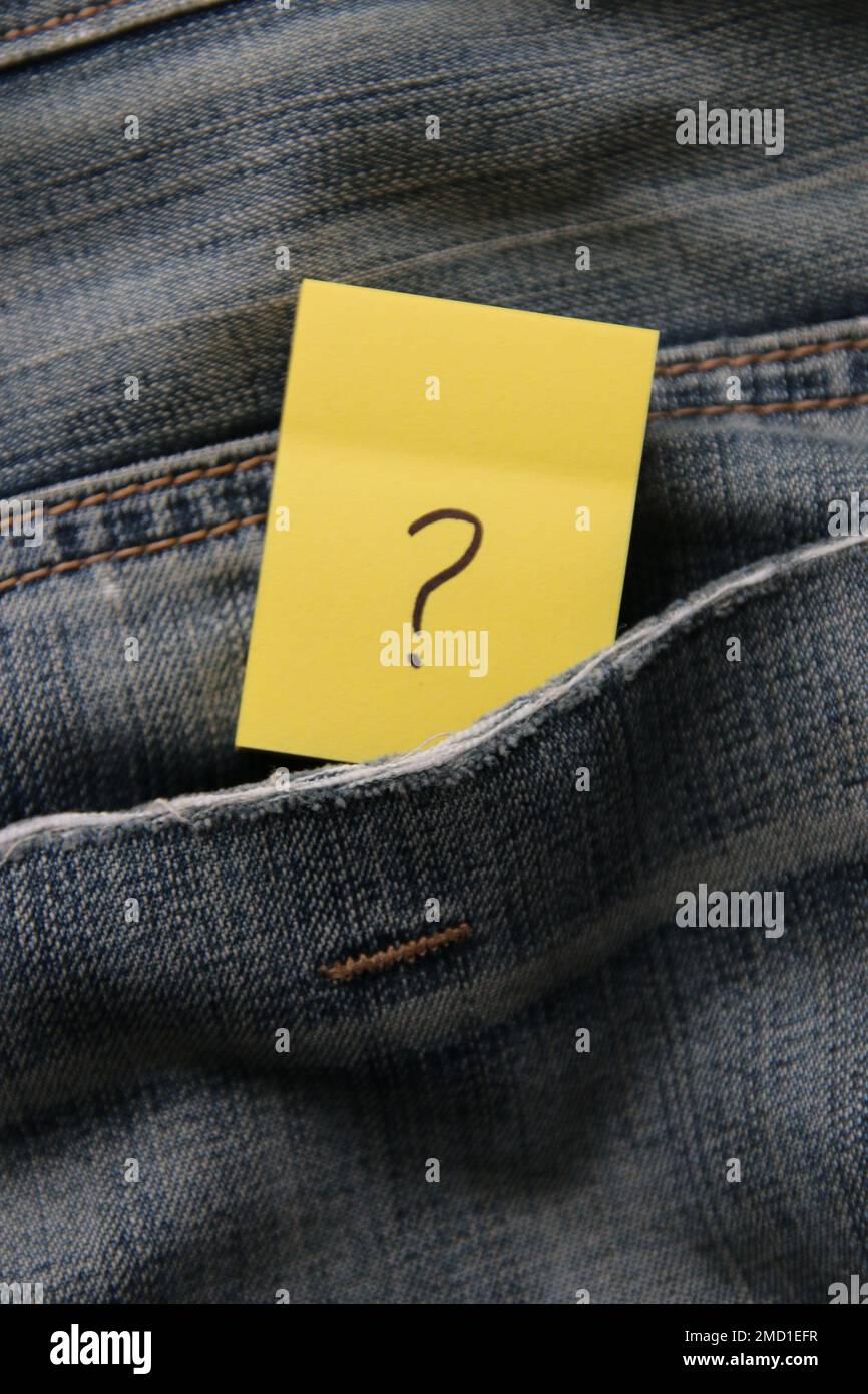 A question mark on a paper tag in a jeans pocket. Question mark on ...