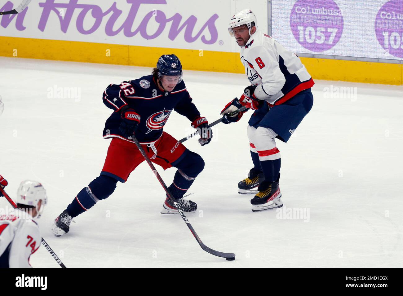 Columbus Blue Jackets forward Alexandre Texier, left, controls the puck ...