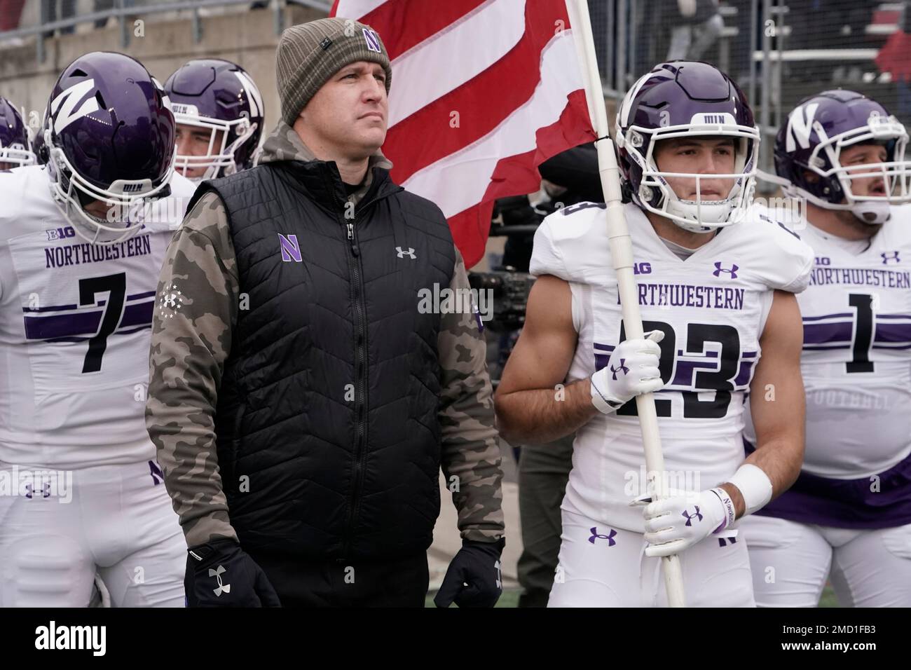 Northwestern head coach Pat Fitzgerald leads his team on the field ...