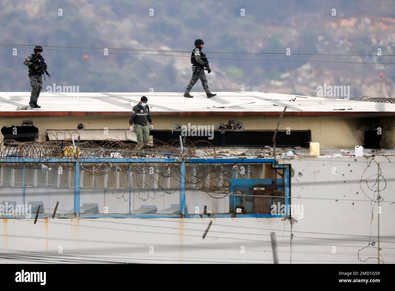 The body of a prisoner appears surrounded by police on the roof of the ...
