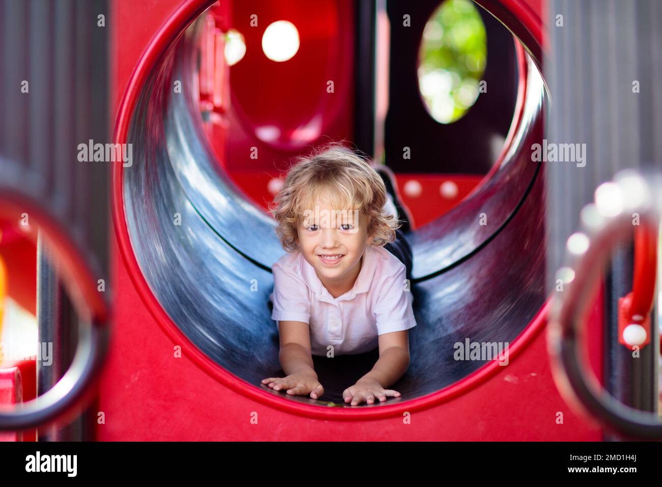Child playing on outdoor playground. Kids play on school or ...
