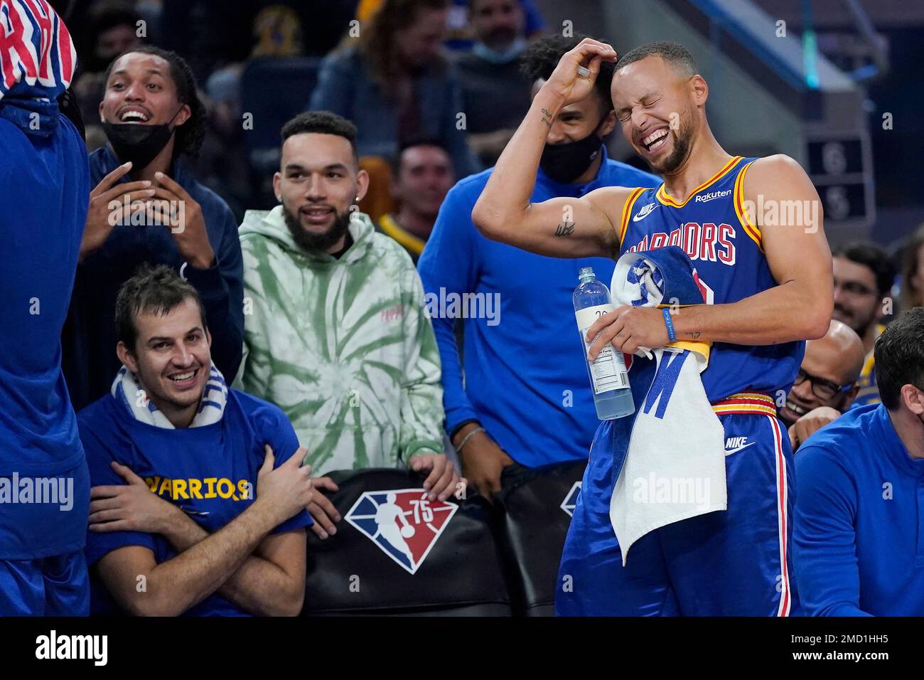 Golden State Warriors guard Stephen Curry, right, laughs with teammates ...