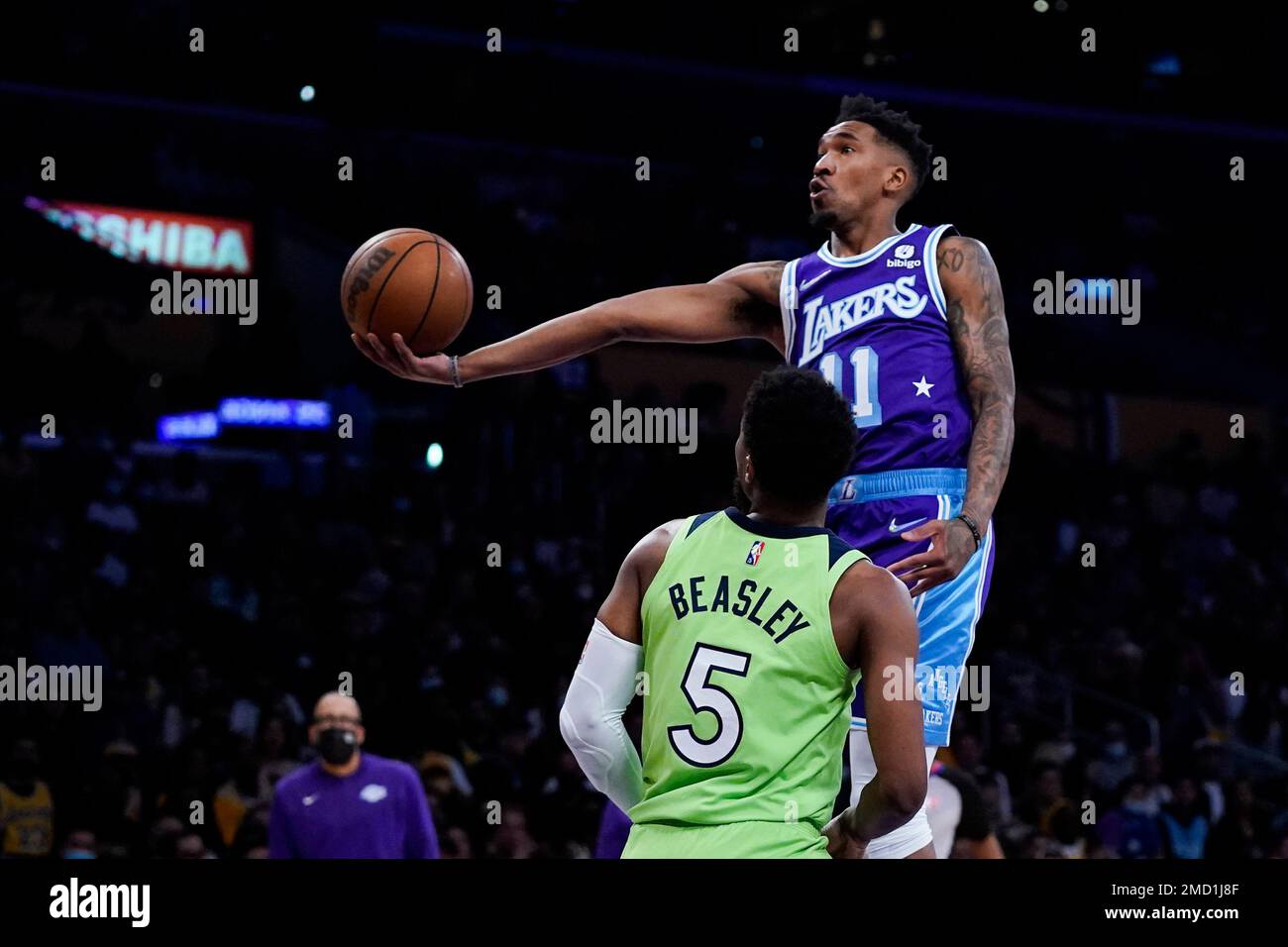 Los Angeles Lakers' Malik Monk, top, goes up for a basket as Minnesota ...