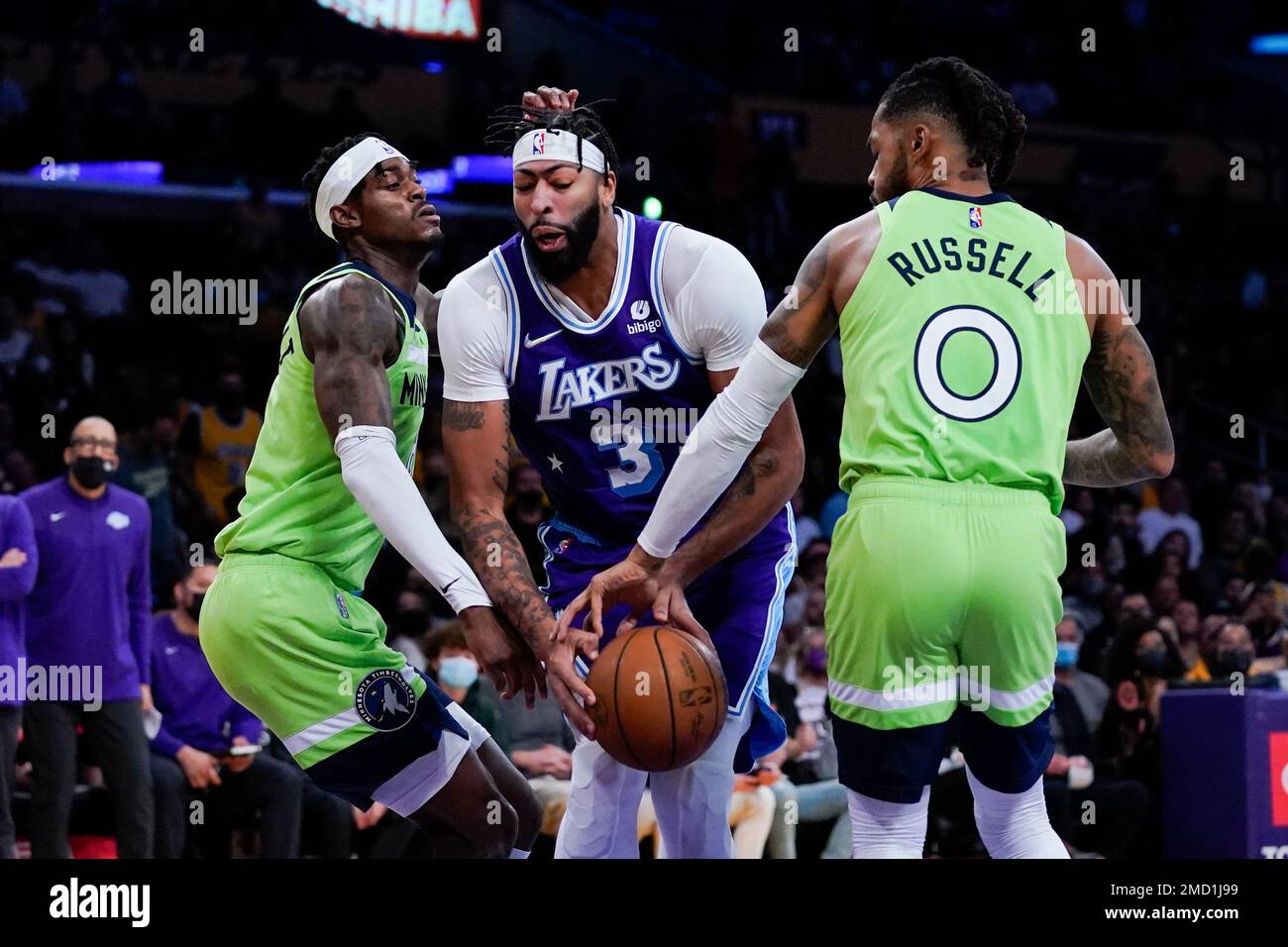 Los Angeles Lakers' Anthony Davis, center, is defended by Minnesota ...