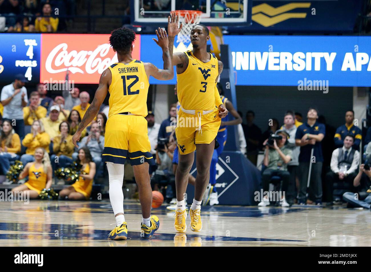 West Virginia guard Taz Sherman (12) and forward Gabe Osabuohien (3 ...