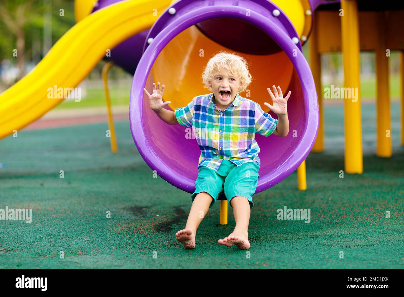 Child playing on outdoor playground. Kids play on school or ...