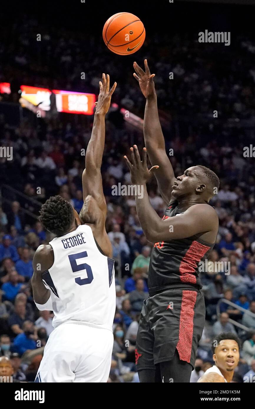 San Diego State forward Aguek Arop, right, shoots as BYU forward Gideon ...