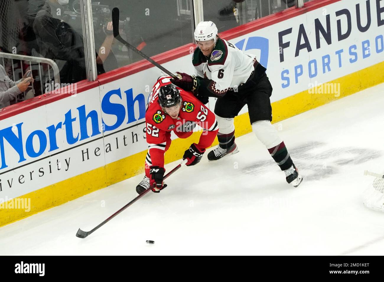 Arizona Coyotes' Jakob Chychrun (6) knocks Chicago Blackhawks' Reese ...