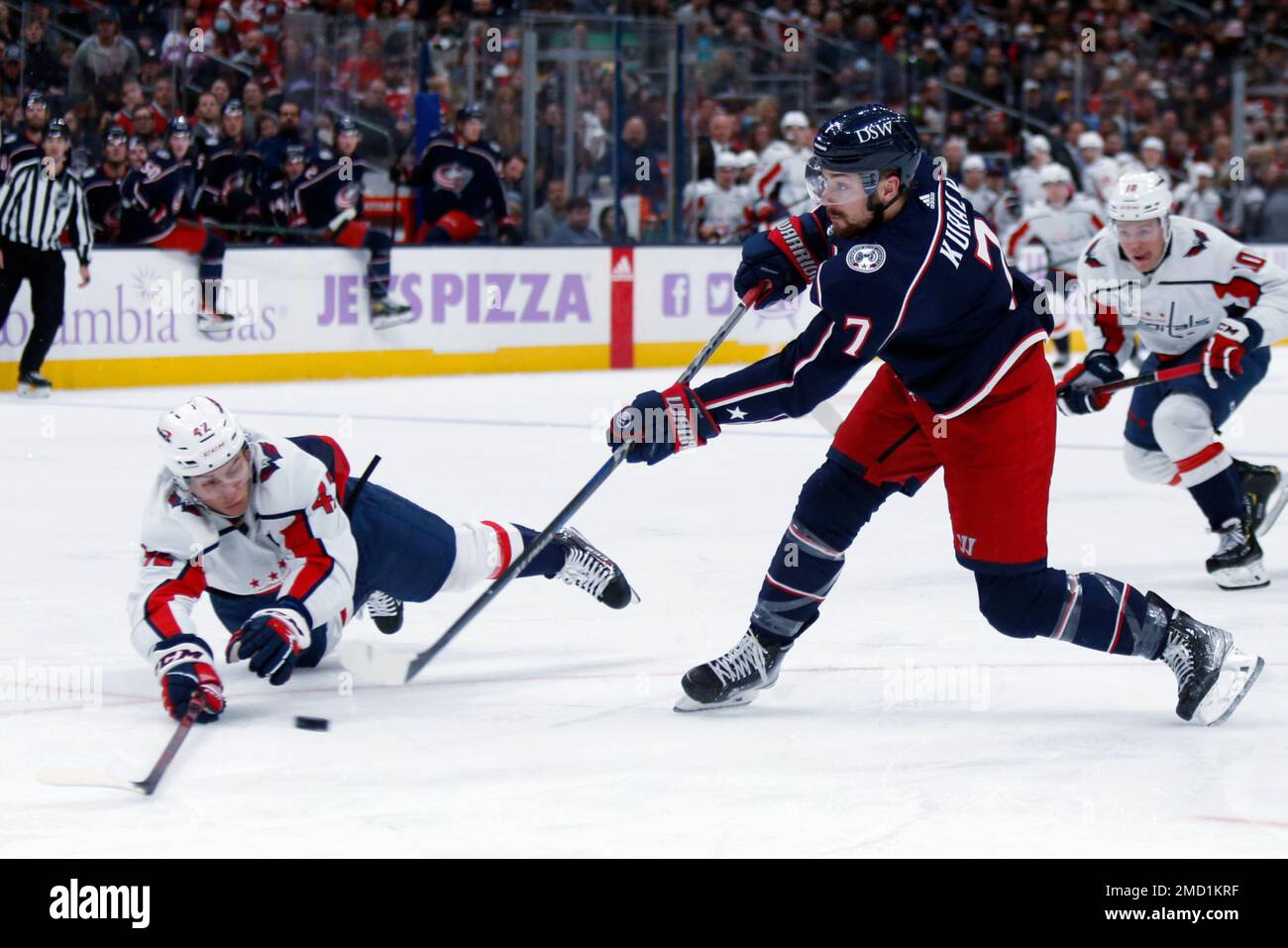 Columbus Blue Jackets forward Sean Kuraly, right, shoots the puck in ...