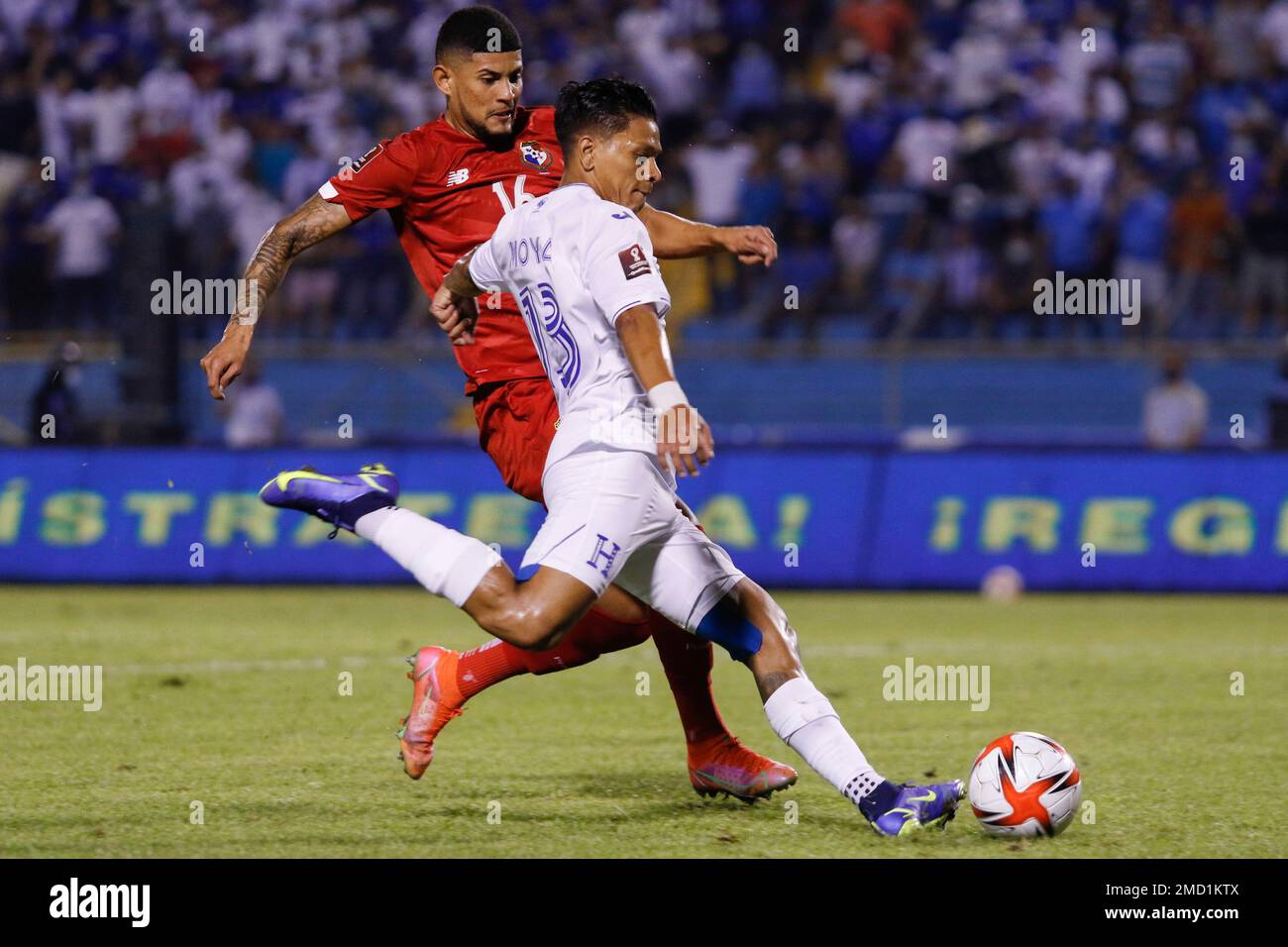 Honduras' Bryan Moya, front, strikes the ball pressures by Panama's Andres Andrade during a ...