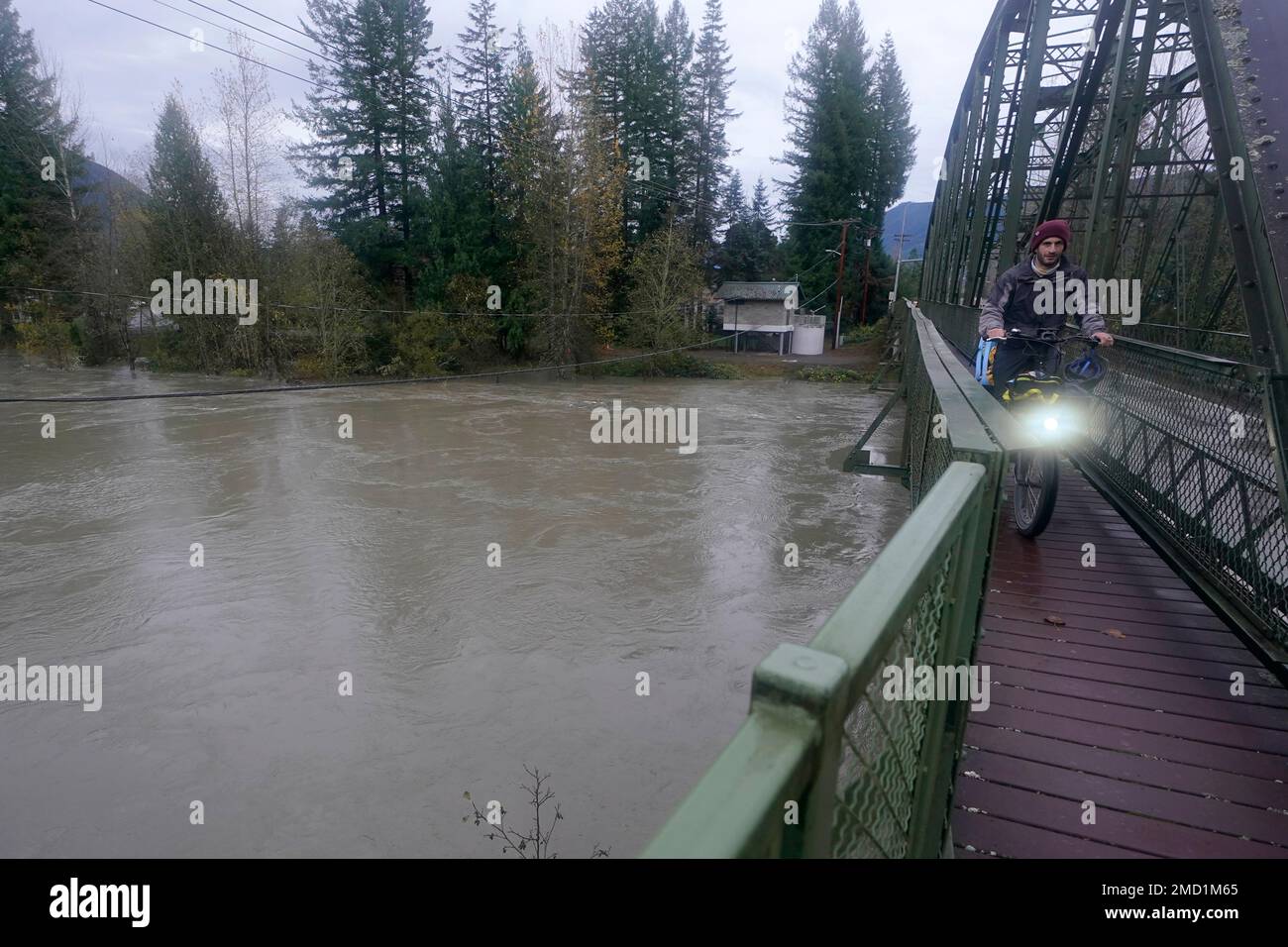 A person rides a bicycle over the Meadowbrook Bridge, Friday, Nov. 12 ...