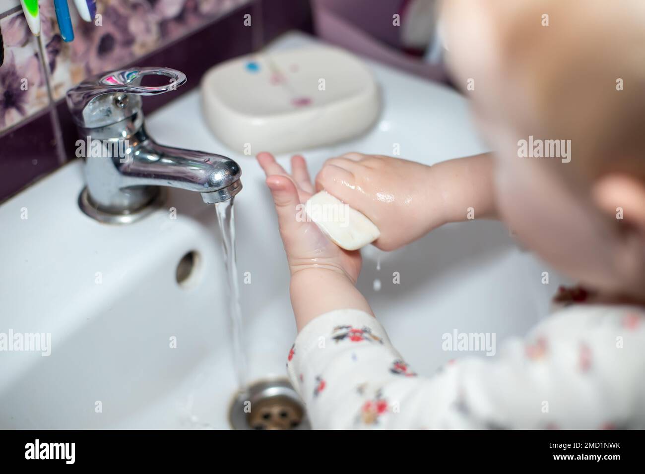Small child washing hands with soap and water, cleaning hand to stop ...