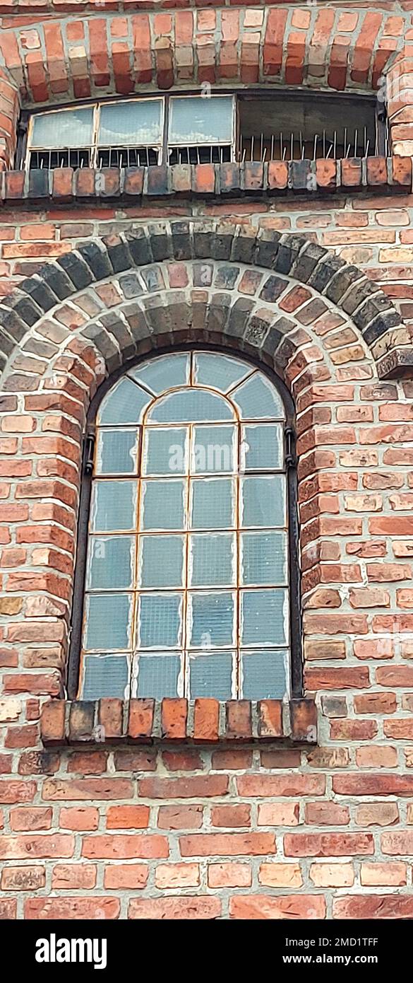 A vertical view of a stone building with a window Stock Photo - Alamy