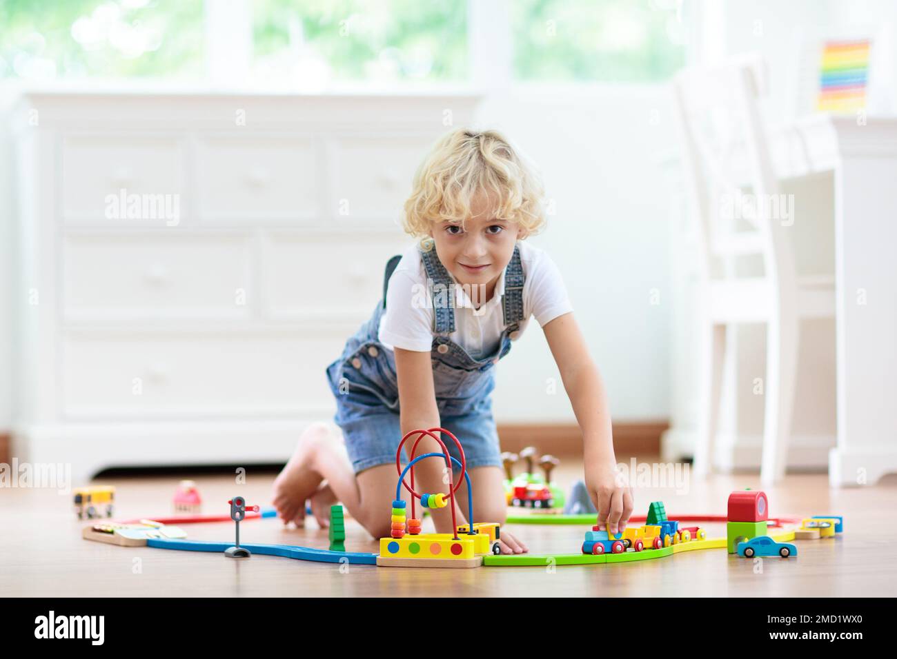 Kids play with wooden railway. Child with toy train. Educational toys ...