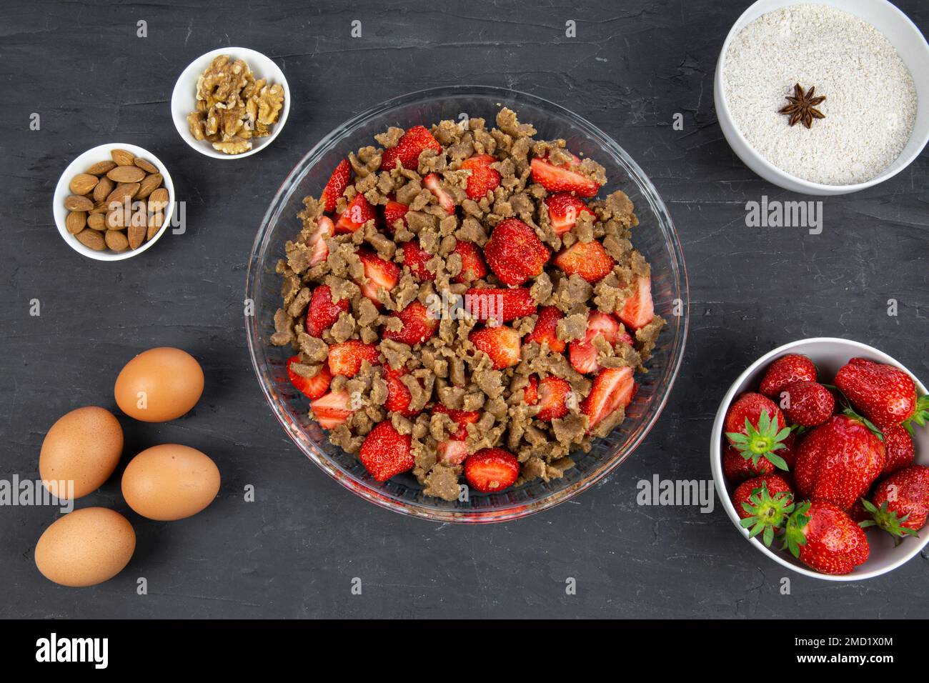 Delicious homemade summer crumble preparation on black table, top view ...