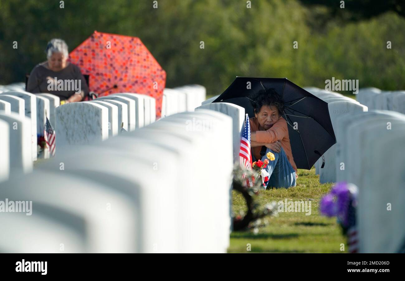 Lam Sandidge, right, visits the grave site of her husband, Maj. Ernie ...