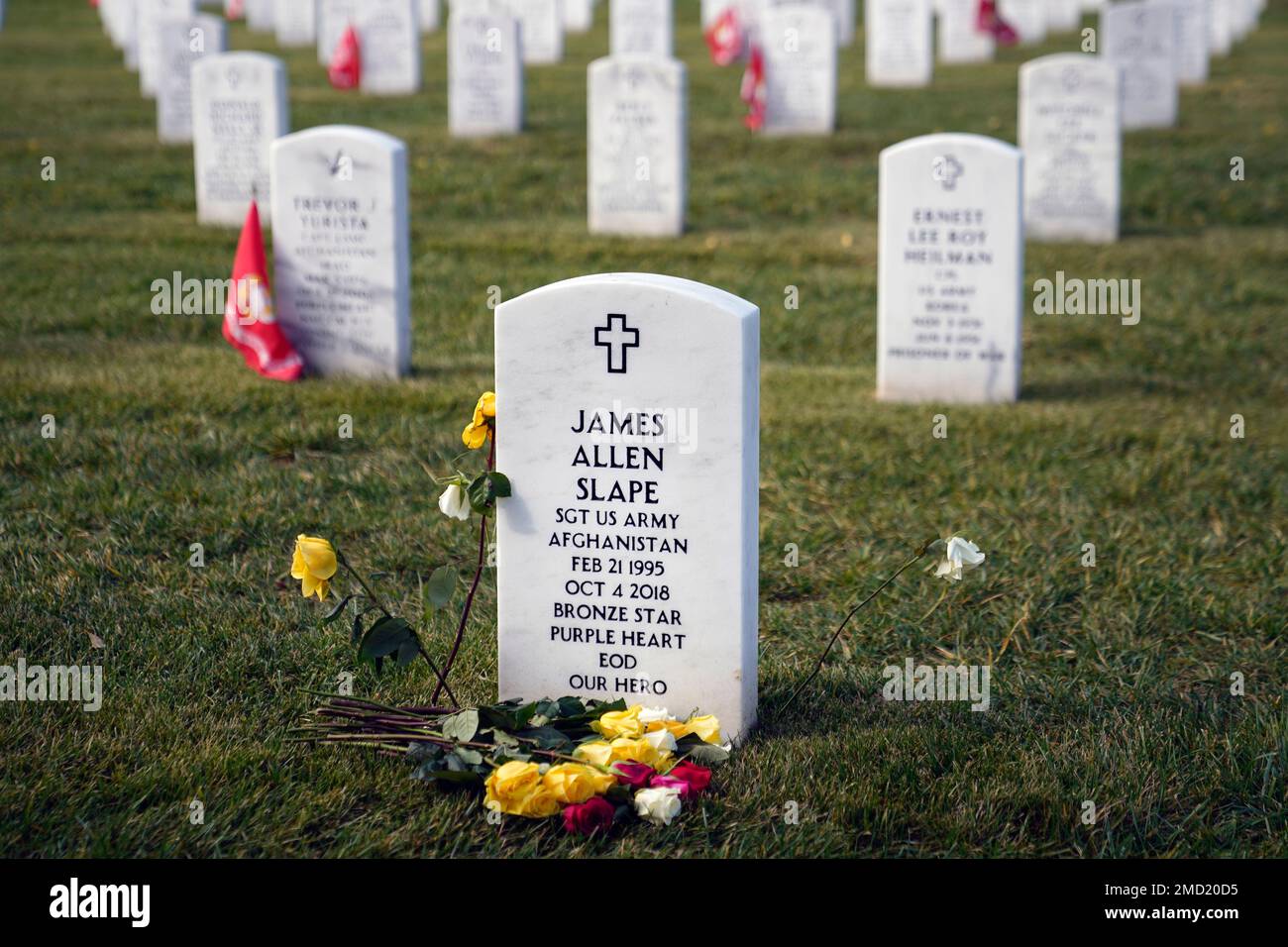 Flowers rest against the headstone of U.S. Army Sgt. James Allen Slape in Section 60 at ...