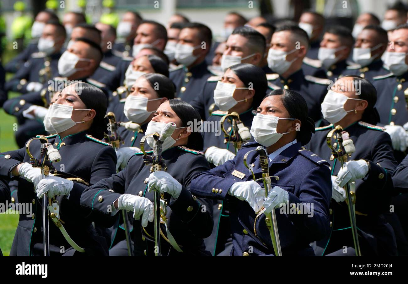 Newly graduated police cadets pray during a ceremony also marking the ...