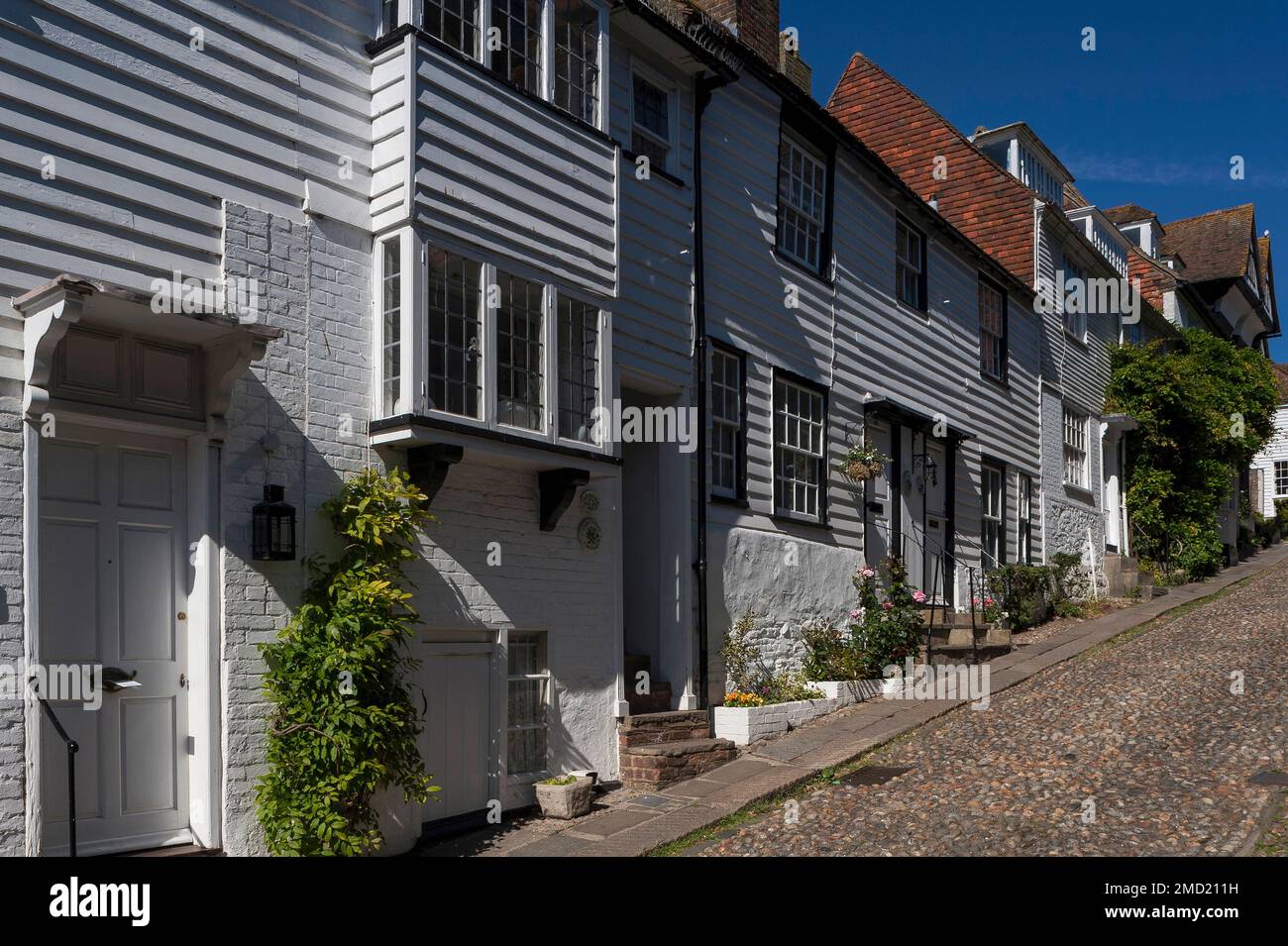 White weatherboarded cottages built in the 1700s form a harmonious ...