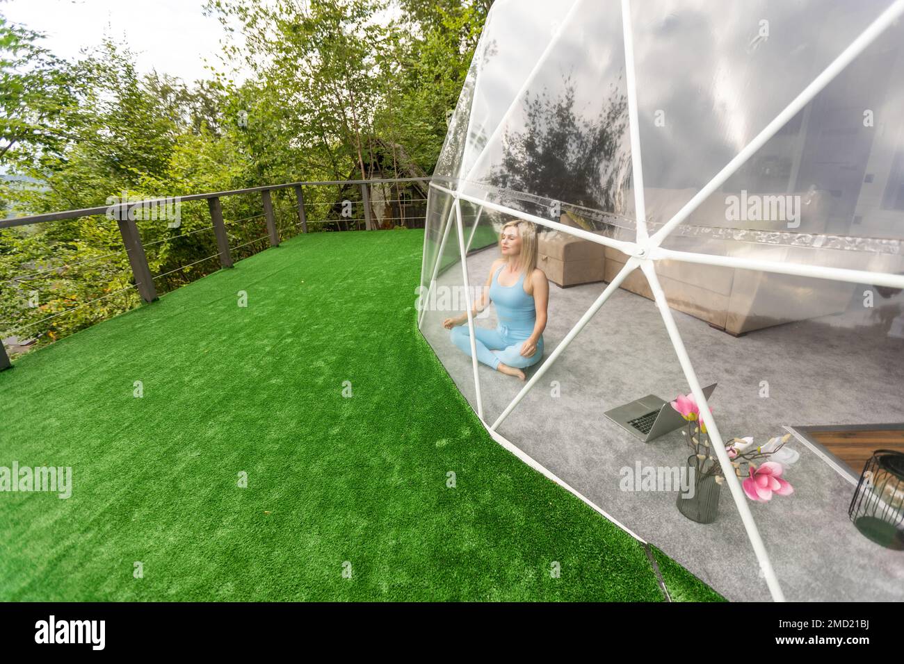 Sporty woman doing exercise in a geo dome glamping tent Stock Photo - Alamy