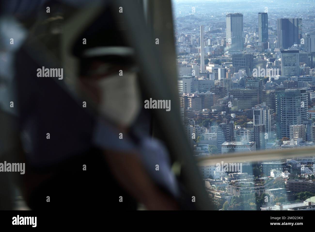 A security guard is reflected on a mirror wall of the observatory ...