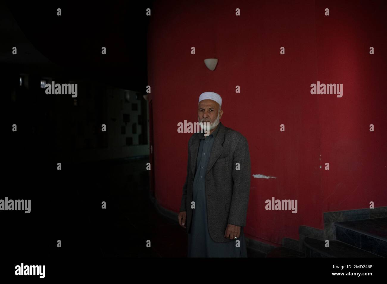 Rahmat Shah, who works as a host, poses for a photograph inside the ...