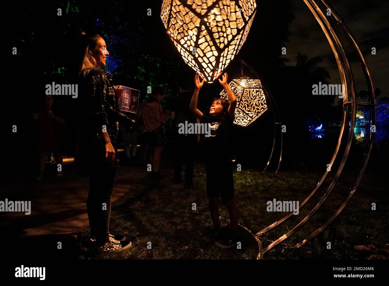 Nathalia Gonzalez, left, and her son Diego Pol, 6, interact with lights ...