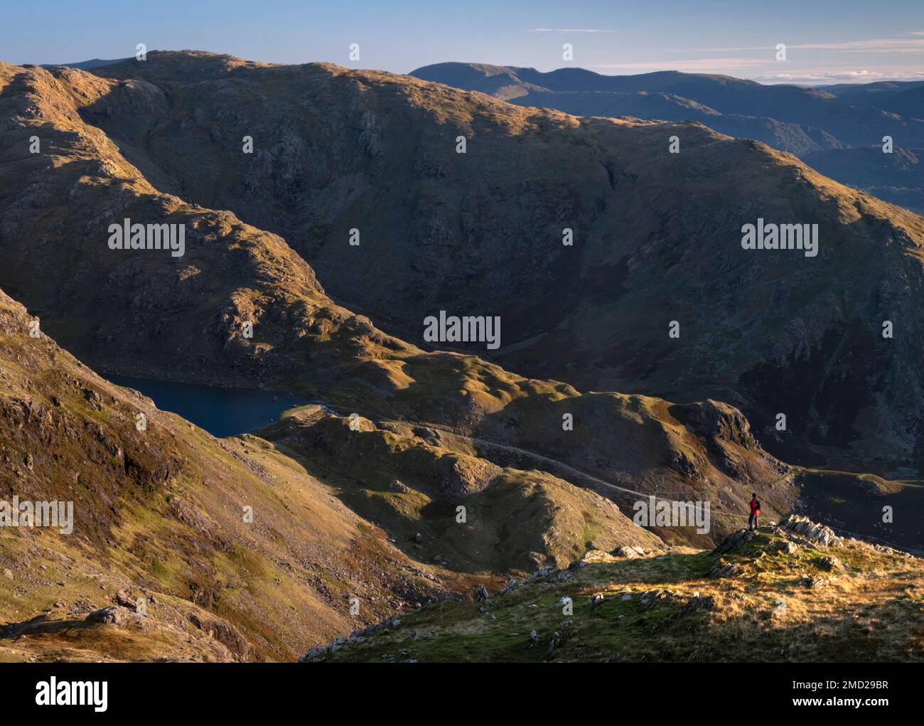 Walker looking over Wetherlam, Levers Water and The Coniston Fells from ...