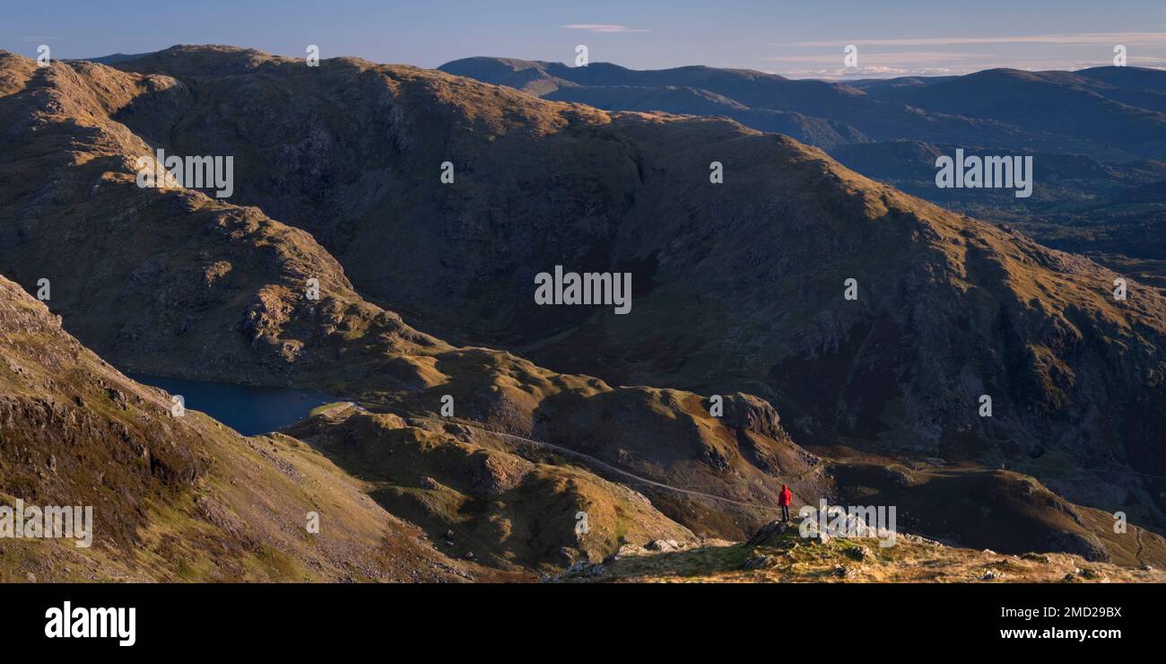Walker looking over Wetherlam, Levers Water and The Coniston Fells from ...