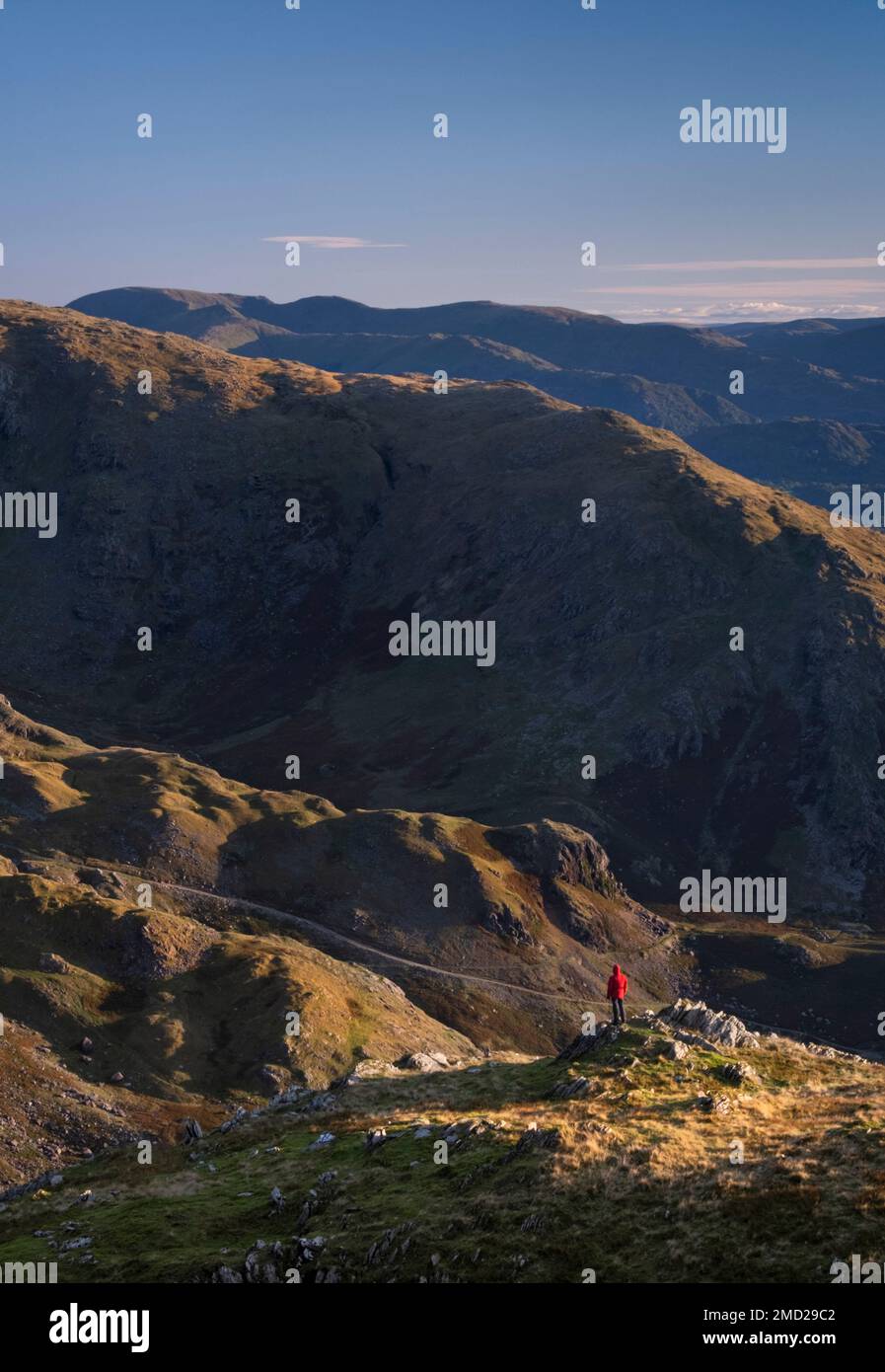 Walker looking over Wetherlam, Levers Water and The Coniston Fells from ...
