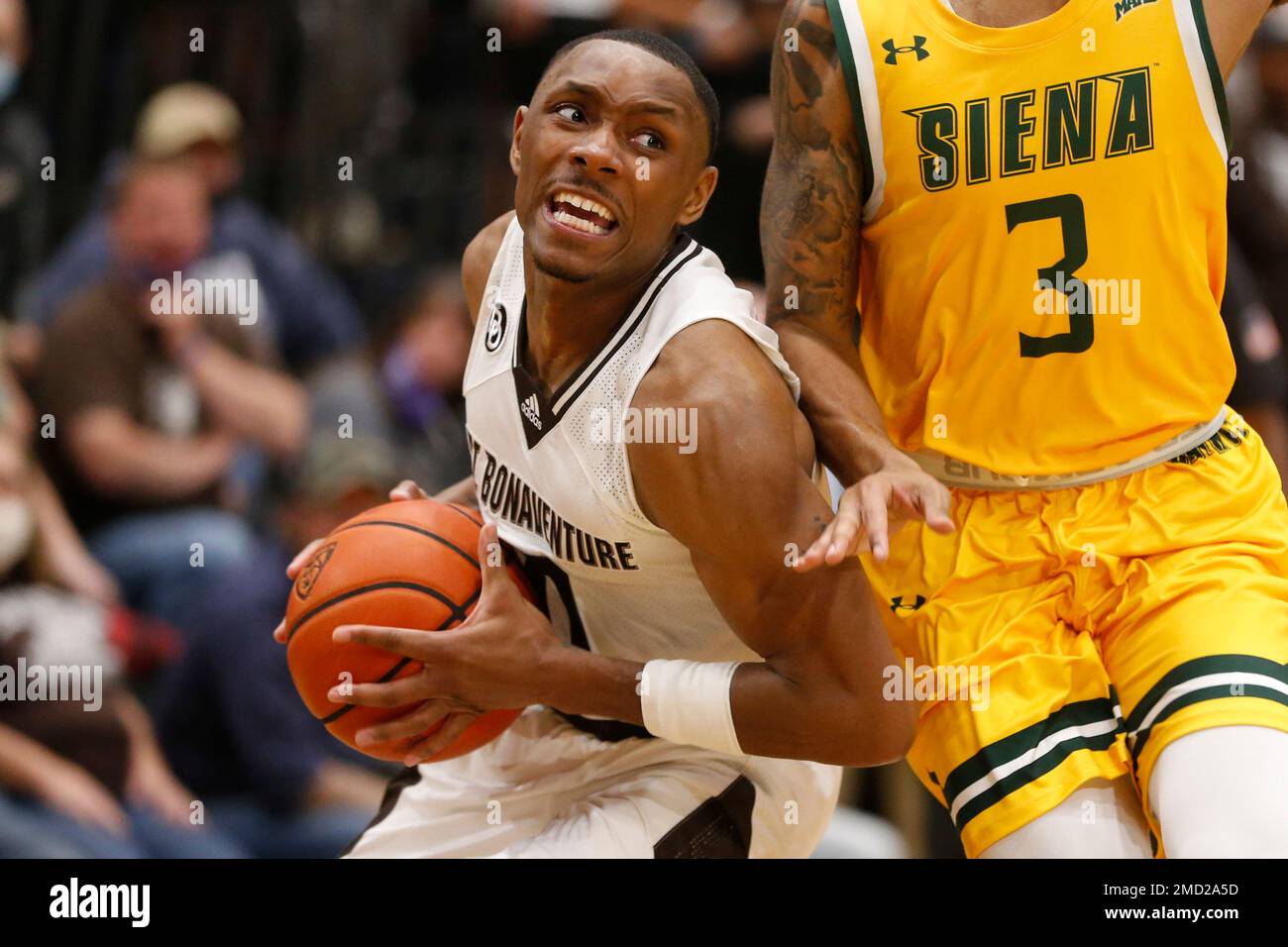 St. Bonaventure guard Kyle Lofton (0) goes up against Siena guard Colby ...