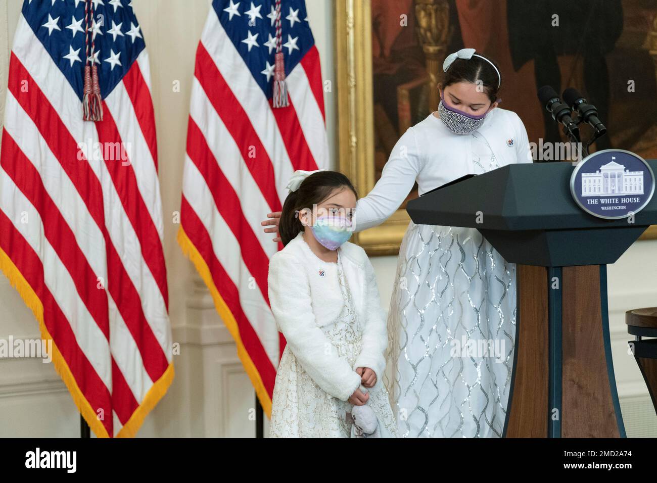 Little caregivers Gabby Rodrigues pats her little sister Eva Rodriguez ...